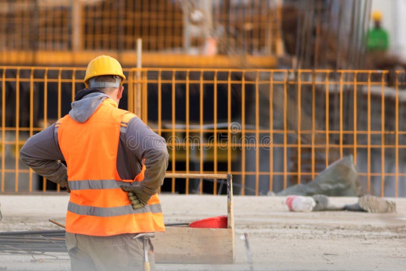 Confused Worker in Orange at the Construction Site Stock Photo - Image ...