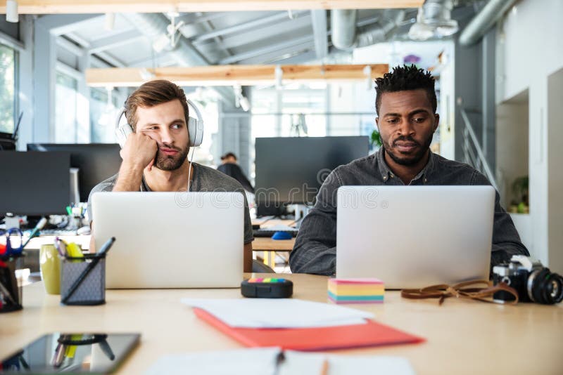 Confused Young Colleagues Sitting in Office Coworking Stock Image ...