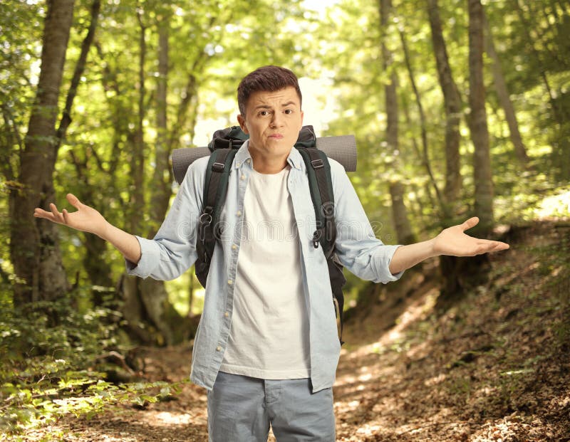Confused Young Male Backpacker Gesturing with Hands Stock Image - Image ...