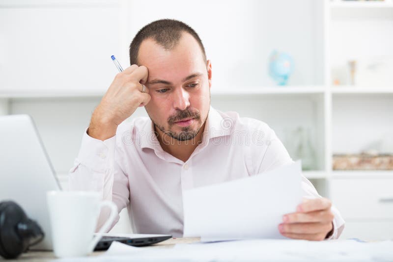 Confused Young Man at Workplace Stock Photo - Image of european, people ...