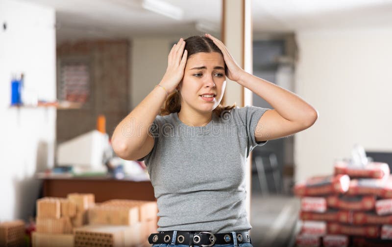 Confused Young Woman Standing in Her Apartment during Renovations Stock ...