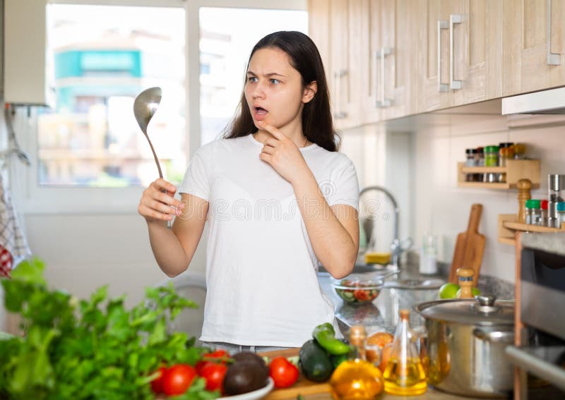 Portrait of Confused Young Woman at Kitchen Stock Photo - Image of ...