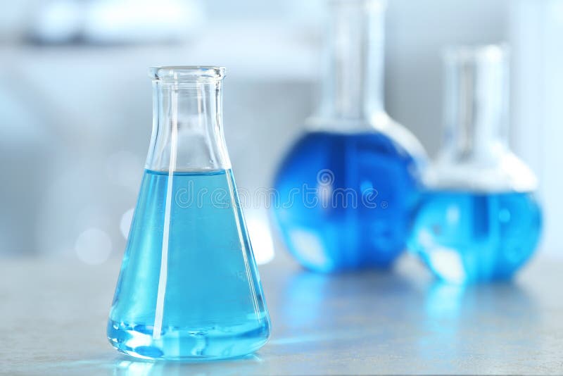 Conical Flask with Blue Liquid on Table in Laboratory. Space for Text ...