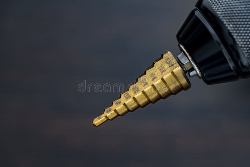 Conical Step Drill Clamped in Electric Screwdriver, Closeup. Step ...