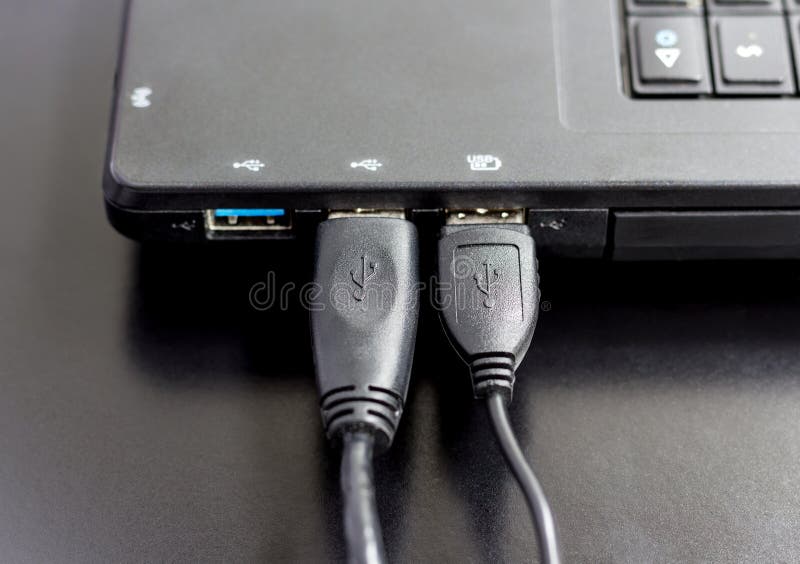 Connect Two USB Cable To Laptop Computer on Black Desk. Stock Photo ...