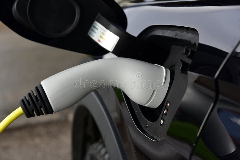 Connected Charging Connector To Electric Car. Loading Energy of an ...