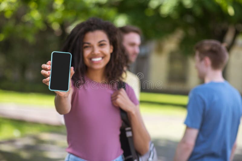 Cute Mulatta with a Smartphone Smiling Nicely Stock Photo - Image of ...