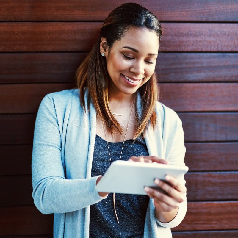 Connected and on the Move. a Businesswoman Using Her Tablet while ...