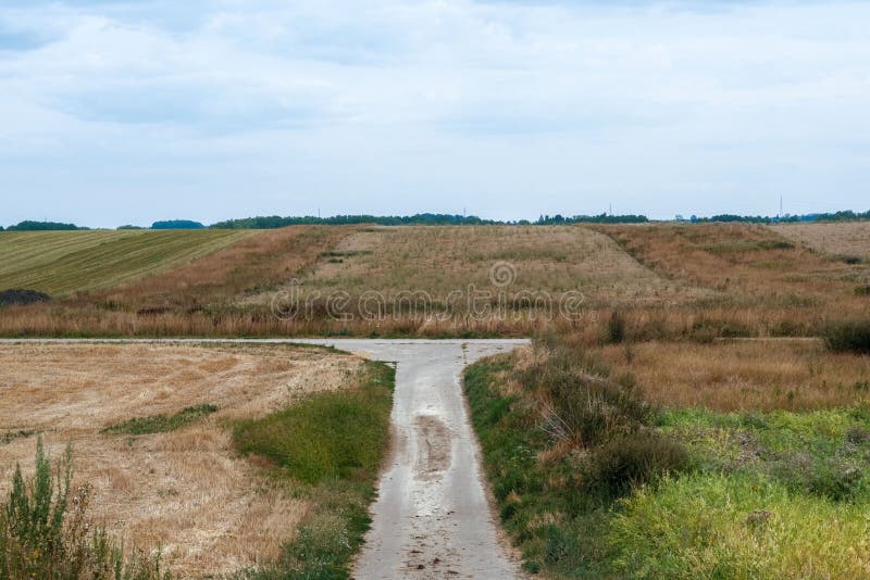 Connecting Road and Feild in the Countryside Under a Cloudy Sky Stock ...