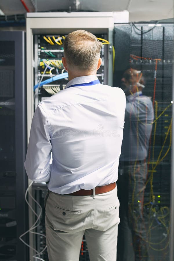 Connecting To the Main Server. Rearview Shot of a Mature Man Working in ...
