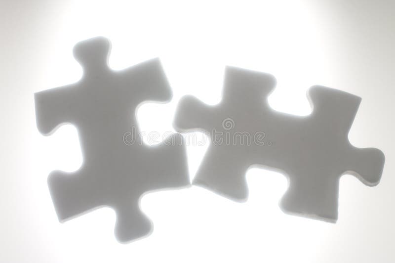 Connecting Two Puzzle Pieces Against the Light. Stock Photo - Image of ...