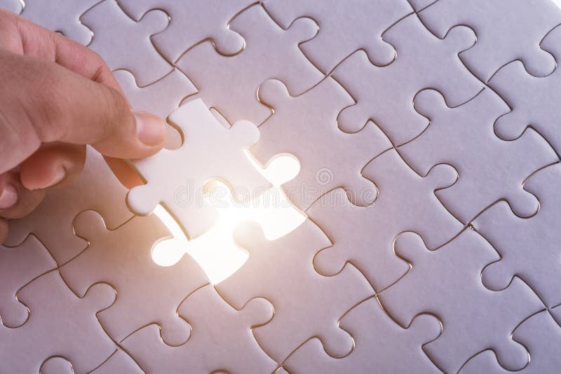 Hand Holding Pieces of Jigsaw Puzzle and Insert into the Missing Stock ...