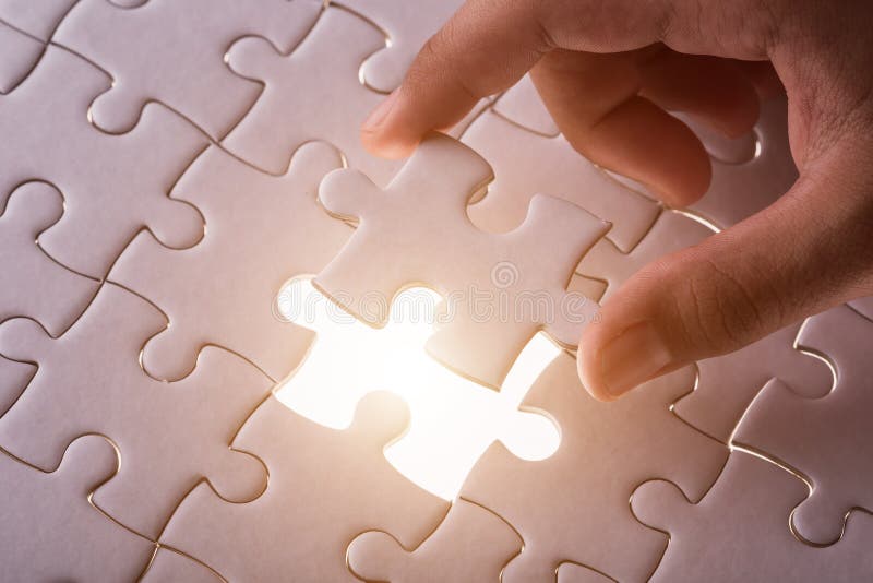 Hand Holding Pieces of Jigsaw Puzzle and Insert into the Missing Stock ...