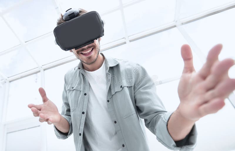 Enjoying New Reality. Attractive Young Man in VR Headset Gesturing and ...