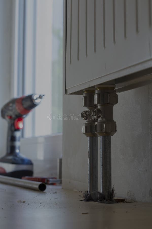 Connection Valves Under a Radiator, on the Floor Much Dust and Dirt ...