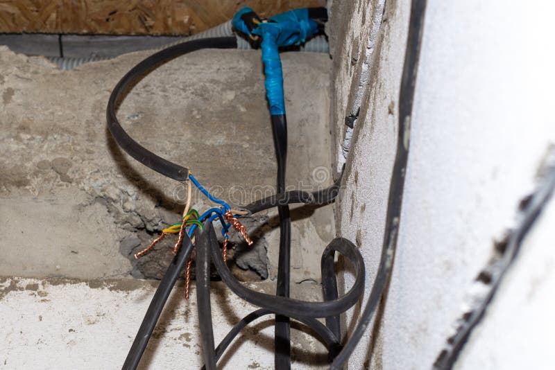 Connection of Wires Against the Background of a Wall in a House Under ...