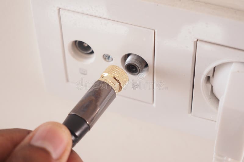 Connector Being Plugged into Wall Socket for Electrical Device Stock ...