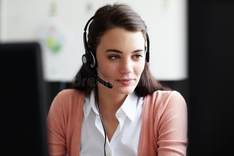 Conscientious Young Worker. a Pretty Young Woman Wearing a Headset ...