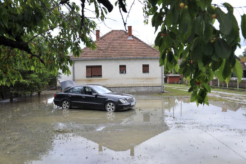 The Consequences of Flooding, Car in Front of Flooded House. Stock ...