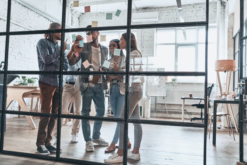 Considering the Next Step. Full Length of Young Modern People in Stock ...