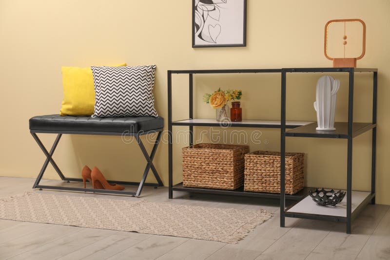 Console Table with Decor and Bench Near Beige Wall in Hallway. Interior ...