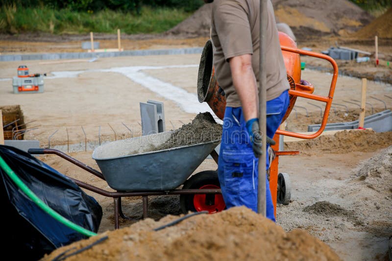 Constriction Worker Making Concrete in an Orange Mixer Stock Image ...