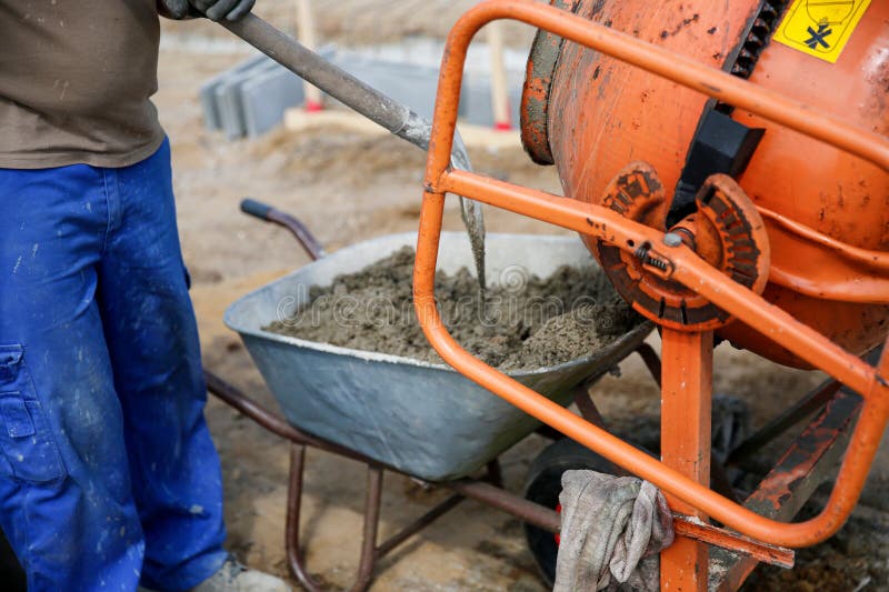 Constriction Worker Making Concrete in an Orange Mixer Stock Photo ...