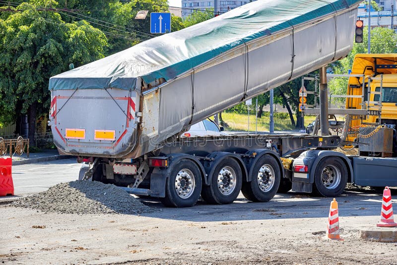 Construction Activity Showcases a Truck Unloading Gravel at a Busy ...