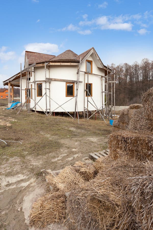 Construction of Adobe House with Thatched Roof and Plastic Windows ...
