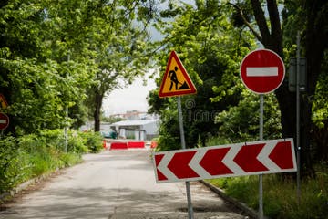 Road Construction Site with Warning Signs and Barriers Surrounded by ...