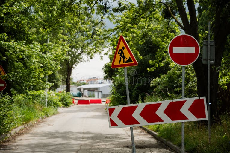Road Construction Site with Warning Signs and Barriers Surrounded by ...