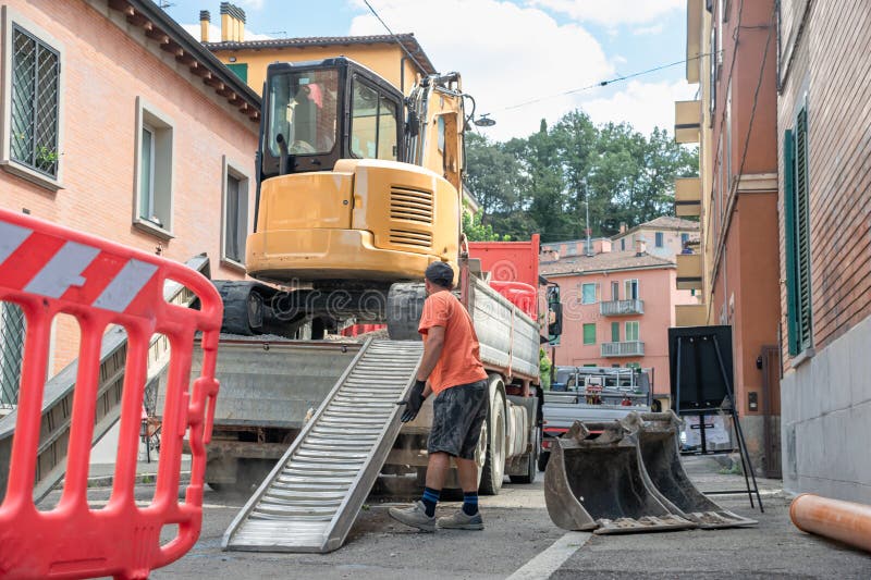 Construction Area with Operators Deploying Barrier, Excavator and ... Construction Area with Operators Deploying Barrier, Excavator and ...