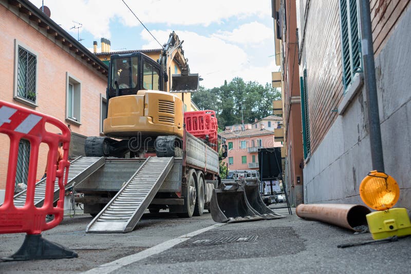 Construction Area with Operators Deploying Barrier, Excavator and ...