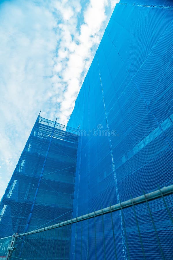 Construction with Blue Scaffolding on a Exterior Facade of a Building ...