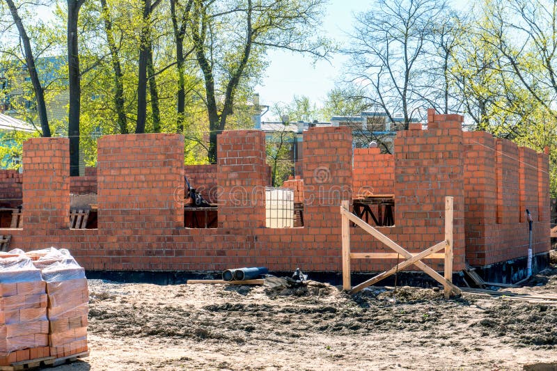 Construction of a Brick House. Construction of Red Brick Masonry Stock ...