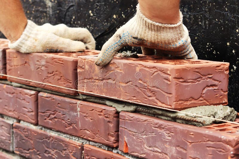 Construction of a Brick Wall. Bricklaying. a Worker Builds a Brick Wall ...