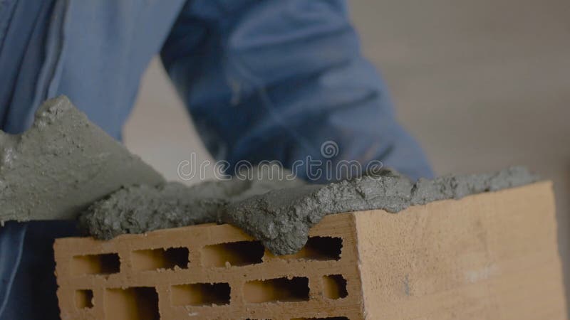 Construction of Brick Wall. Trowel Spreading Cement on Bricks Stock ...