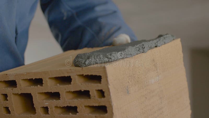 Construction of Brick Wall. Trowel Spreading Cement on Bricks Stock ...