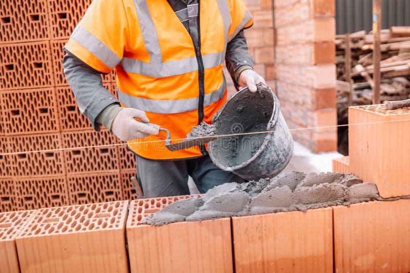Construction Bricklayer Worker Building Walls with Bricks, Mortar and ...