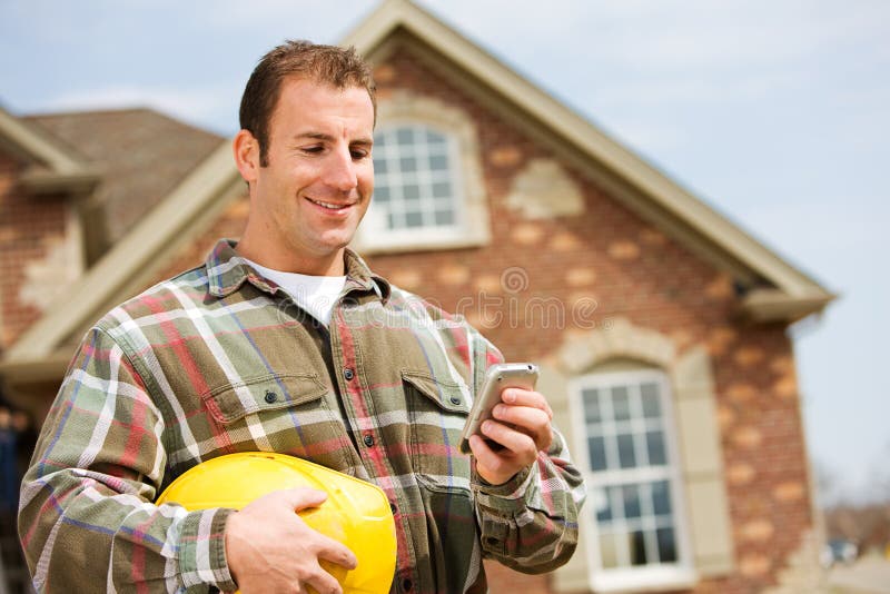 Construction: Builder Using Cell Phone Stock Photo - Image of ...