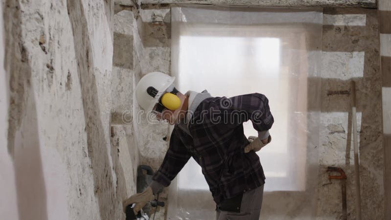 Construction Builder Worker on Building Site Using a Demolition Hammer ...
