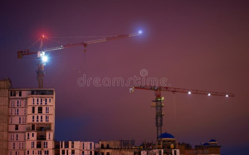 Construction of a Building by Cranes at Night Stock Photo - Image of ...