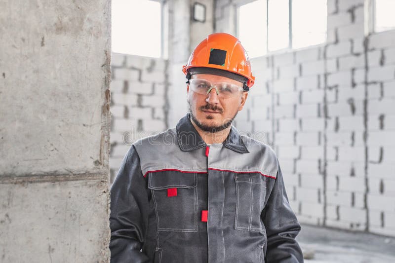 Construction Caucasian Worker in Hard Hat, Overalls and Safety Glasses ...