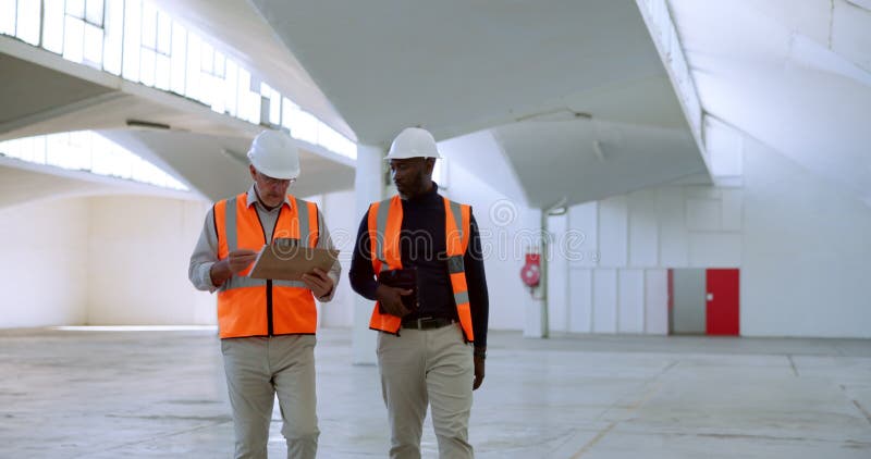 Construction, Checklist and People with Discussion in Warehouse for Progress, Update and ...