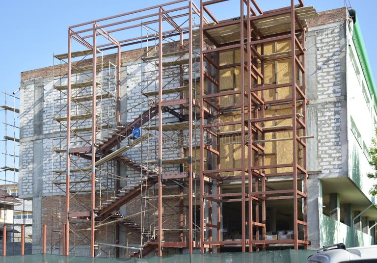 Construction of a Commercial Building. Scaffolding is Fixed on the ...