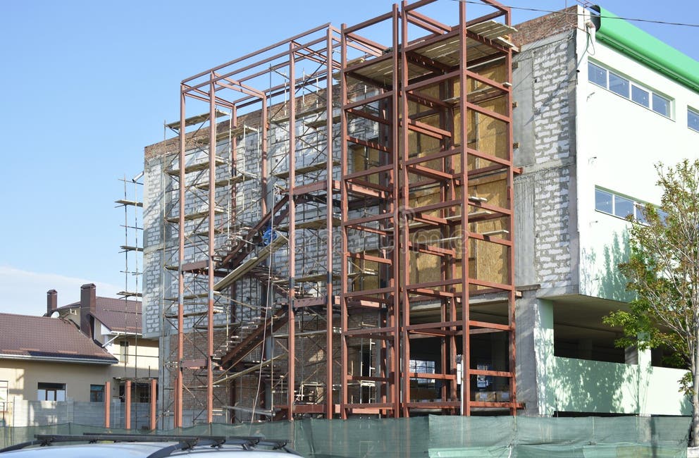 Construction of a Commercial Building. Scaffolding is Fixed on the ...