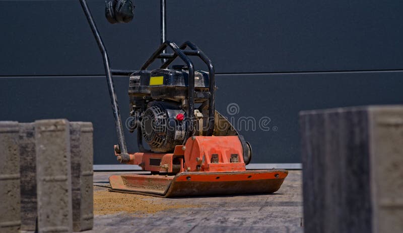 Construction Compactor, on a Freshly Paved Driveway . Stock Photo ...