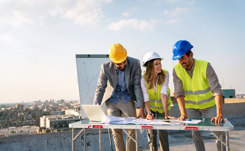 Construction Concept. Engineers and Architects Working at Construction Site with Blueprint Stock ...