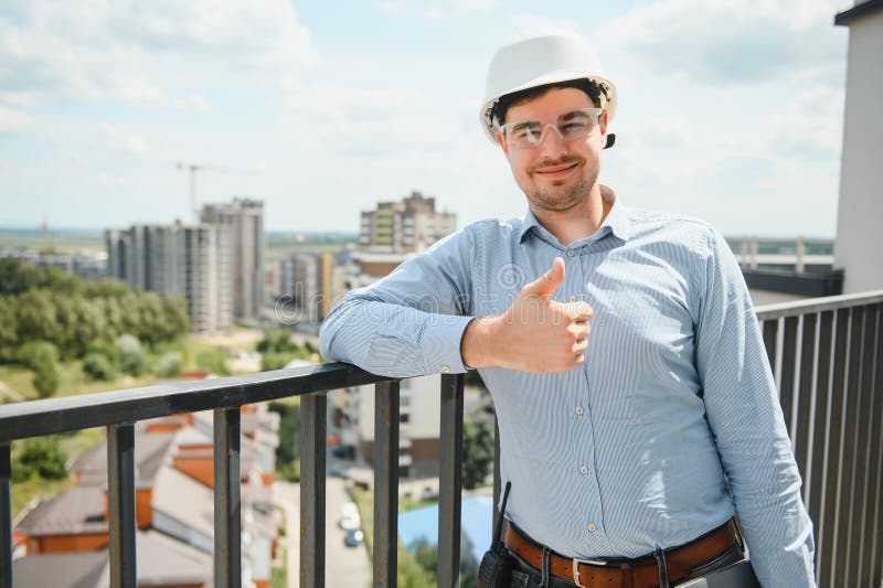 Construction Concept. Portrait of a Young Architect at a Construction ...