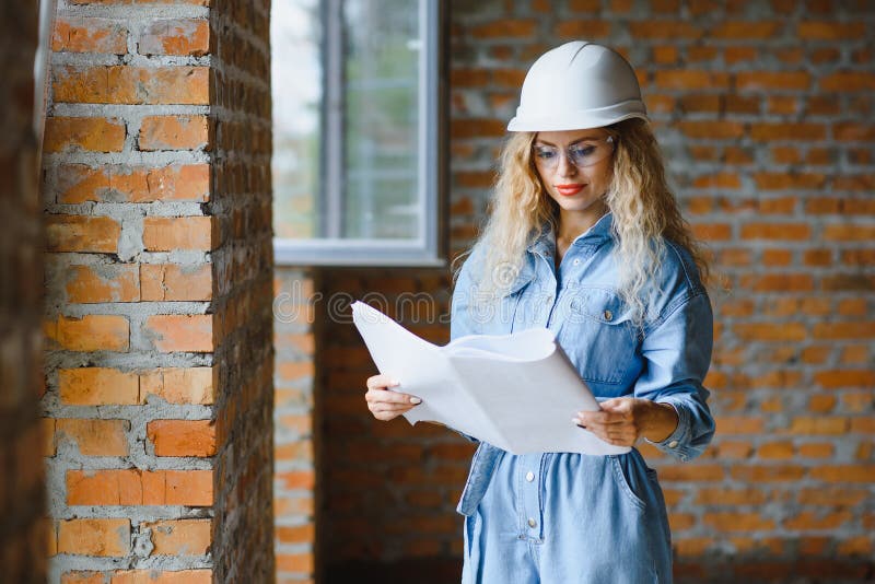 Construction Concept. Pretty Female Builder in Overalls and Helmet ...